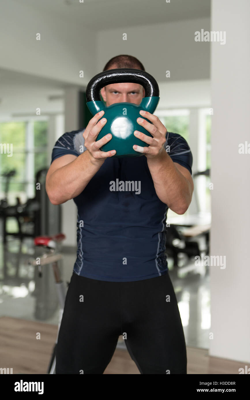 Man Working Out With Kettle Bell In A Gym - Bodybuilder Doing Heavy ...