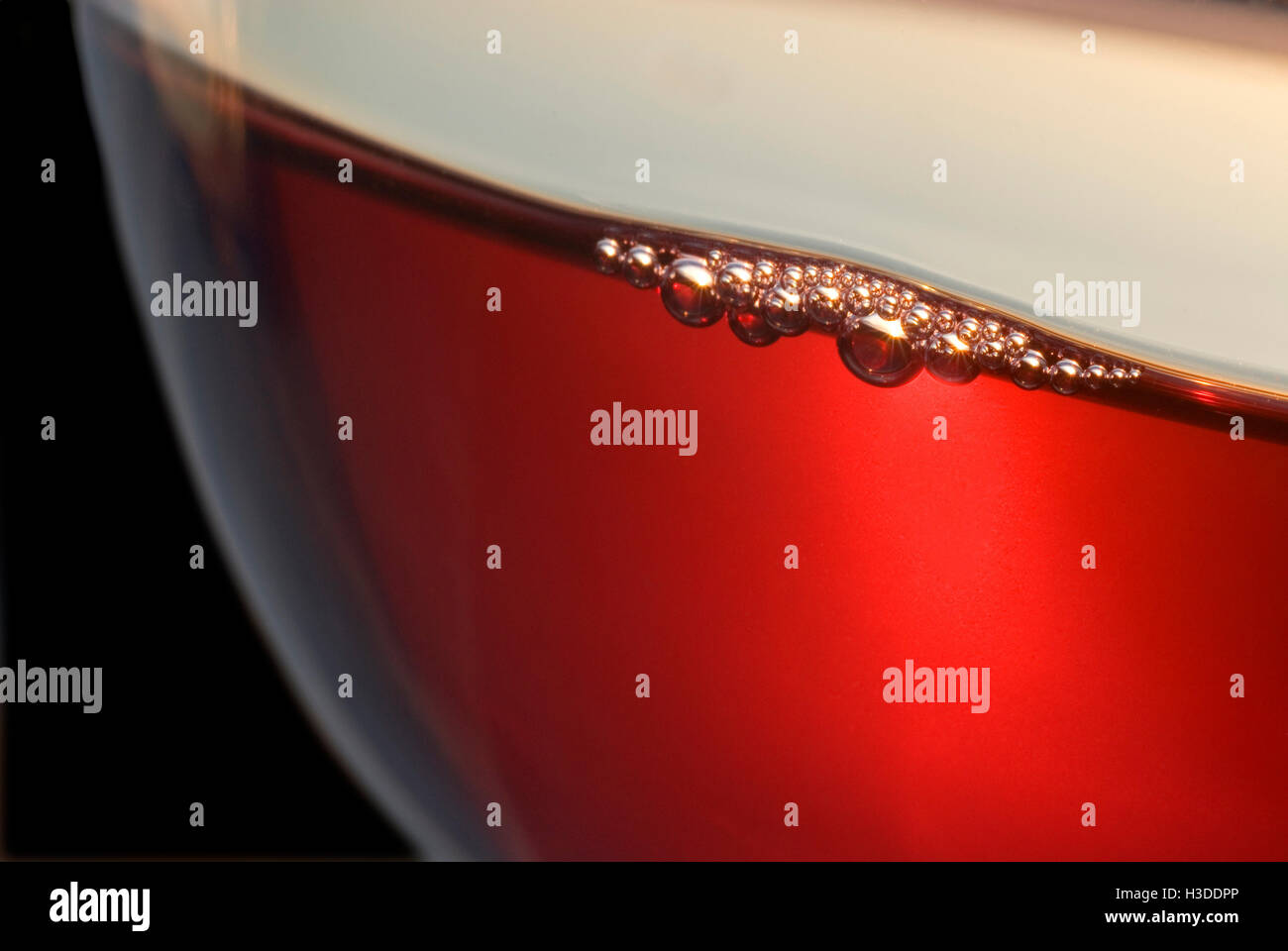 Wine aeration bubbles forming in a freshly poured aerated glass of red ...