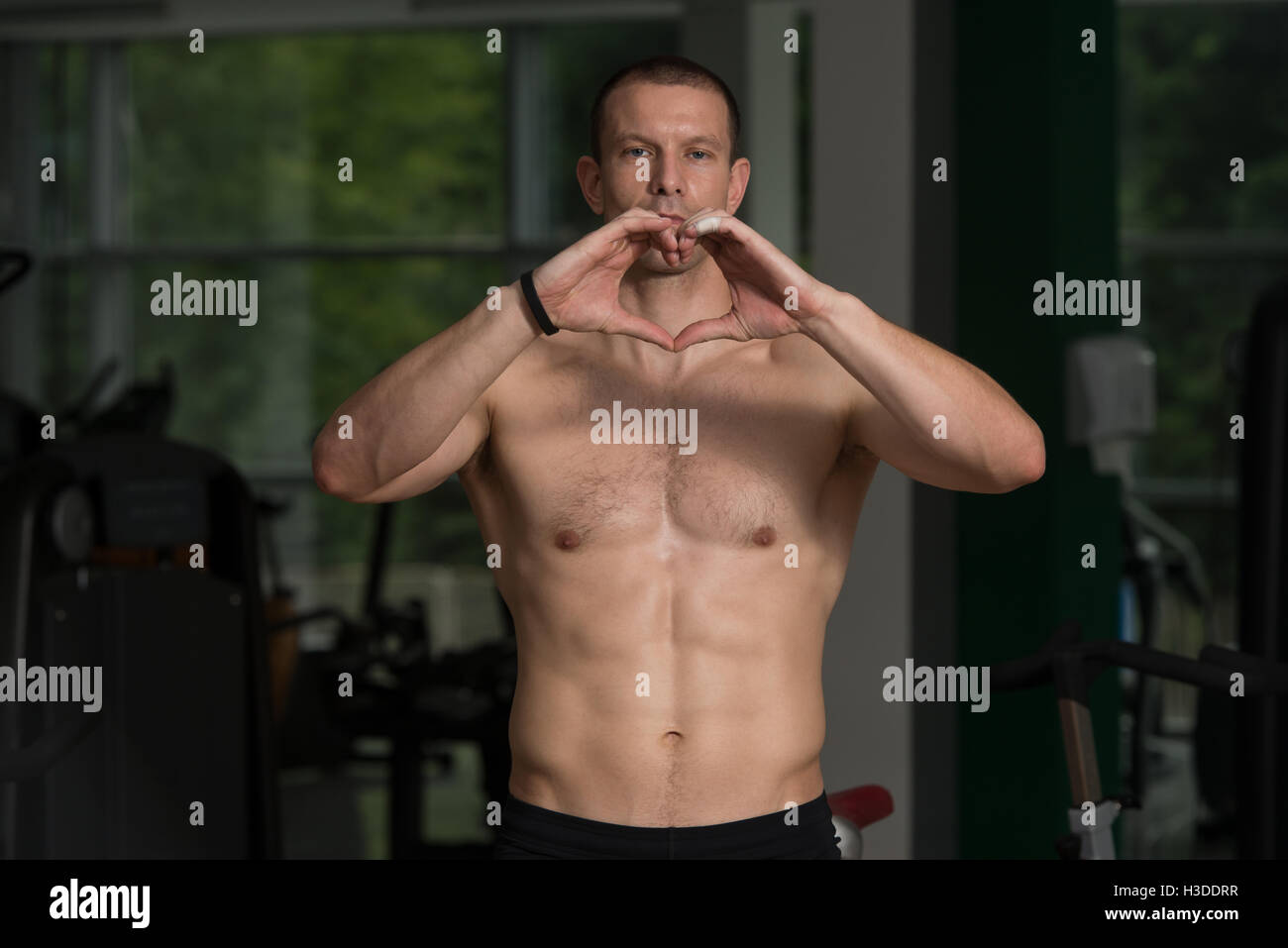 Portrait Of A Young Physically Fit Man Showing Heart With Hands ...