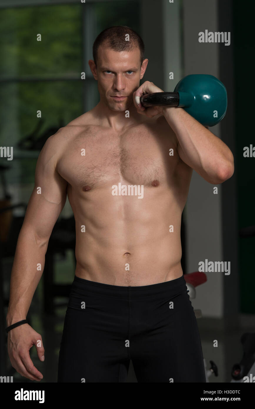 Man Working Out With Kettle Bell In A Gym - Bodybuilder Doing Heavy ...