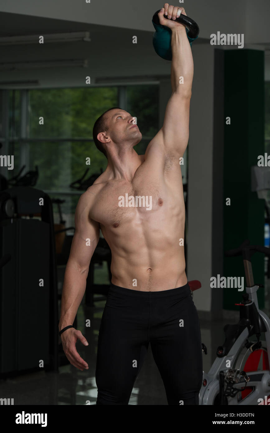 Man Working Out With Kettle Bell In A Gym - Bodybuilder Doing Heavy ...