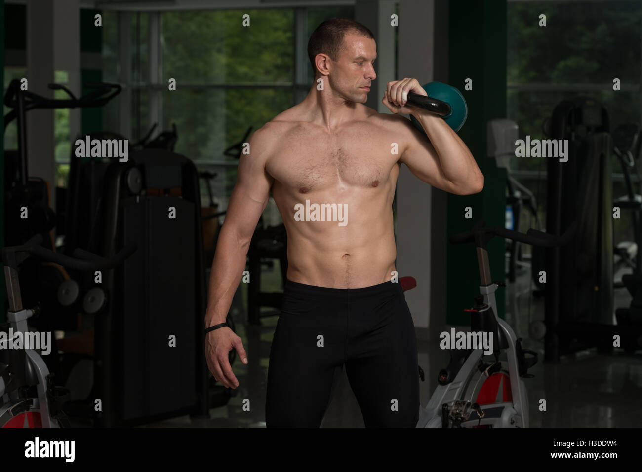 Man Working Out With Kettle Bell In A Gym - Bodybuilder Doing Heavy ...