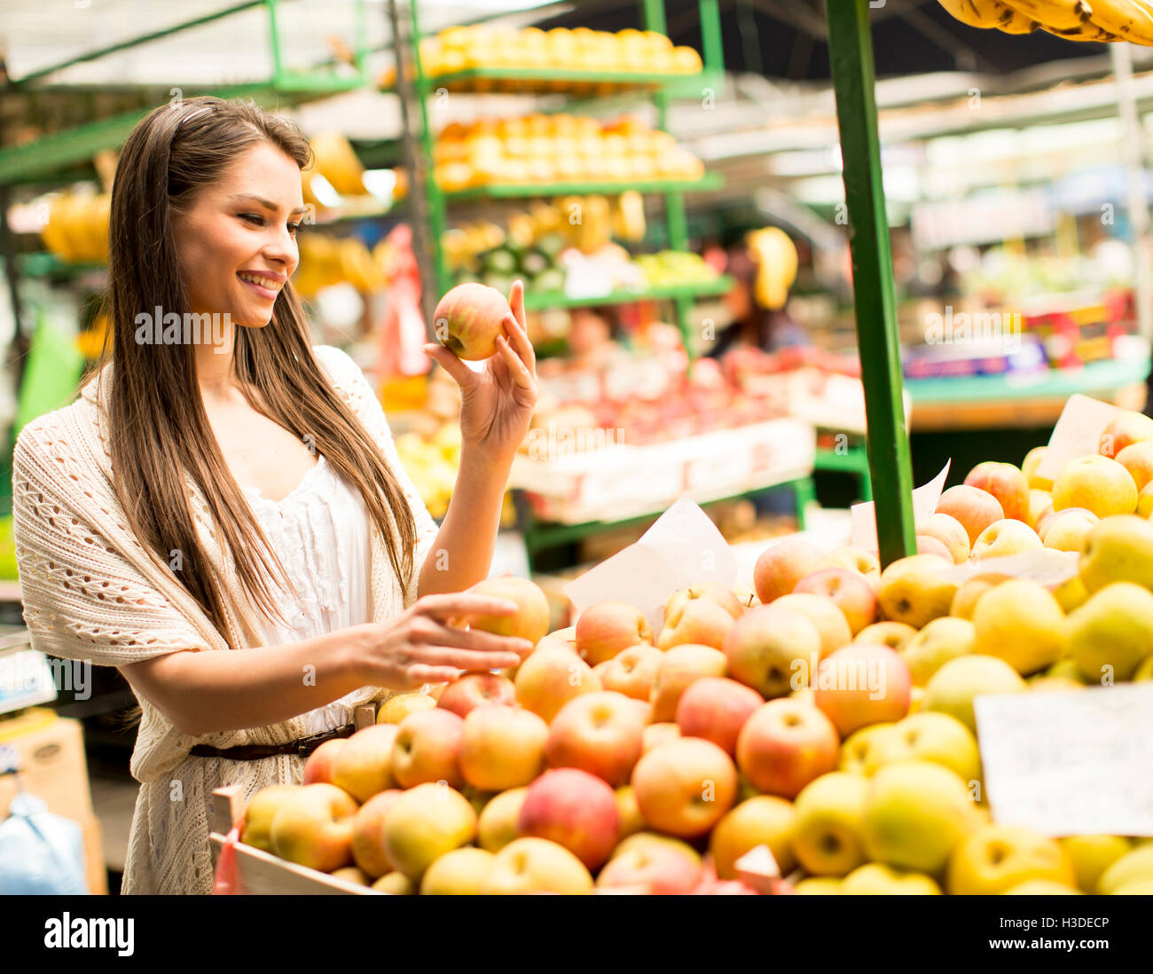 Young woman buying fruit at the market Stock Photo - Alamy