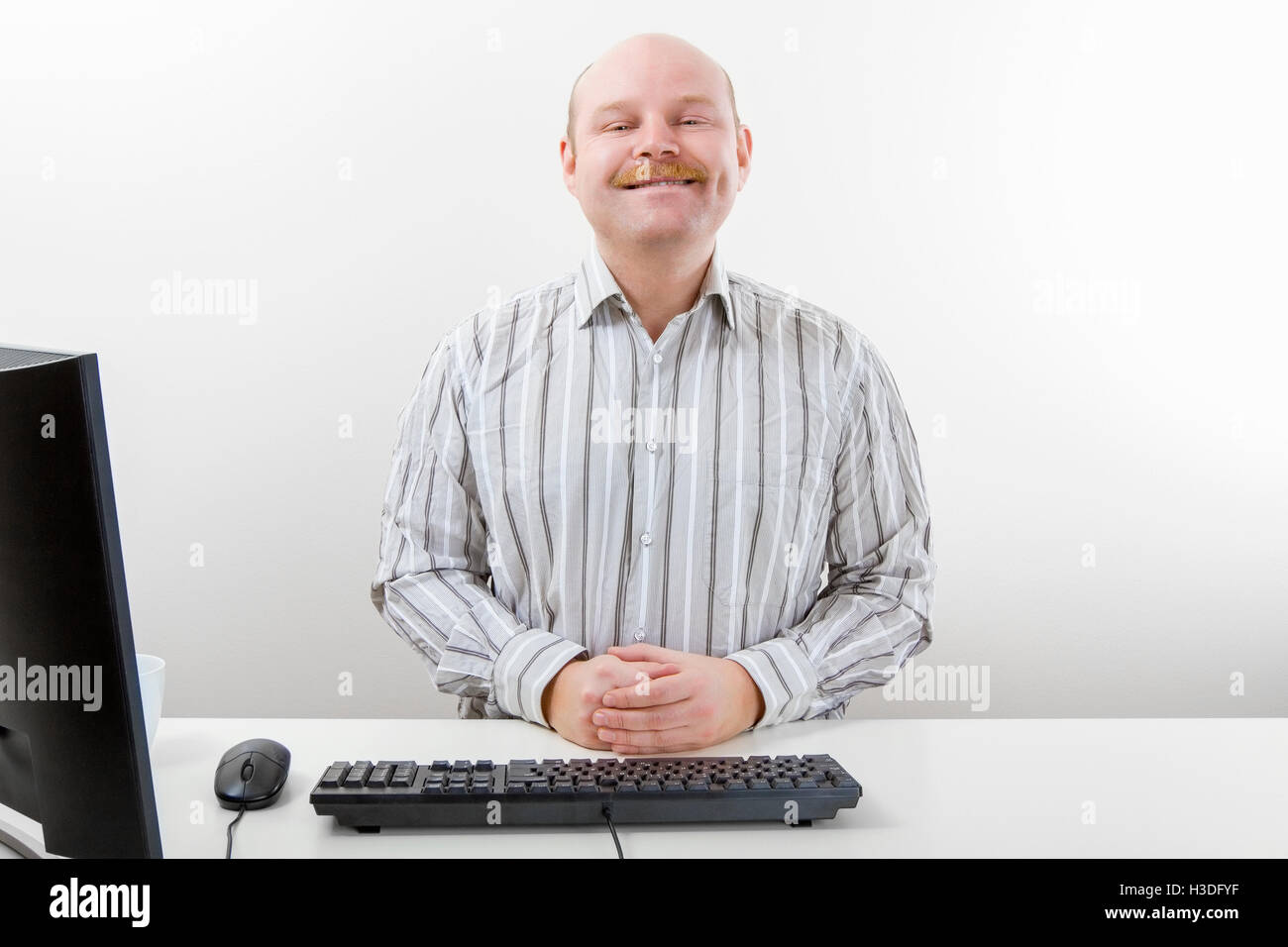Confident Businessman Smiling At Computer Desk Stock Photo - Alamy