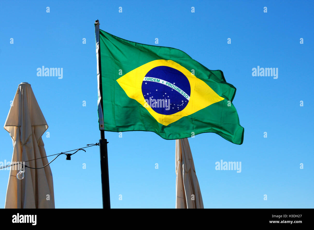 Brazil Flag and blue sky background Stock Photo - Alamy