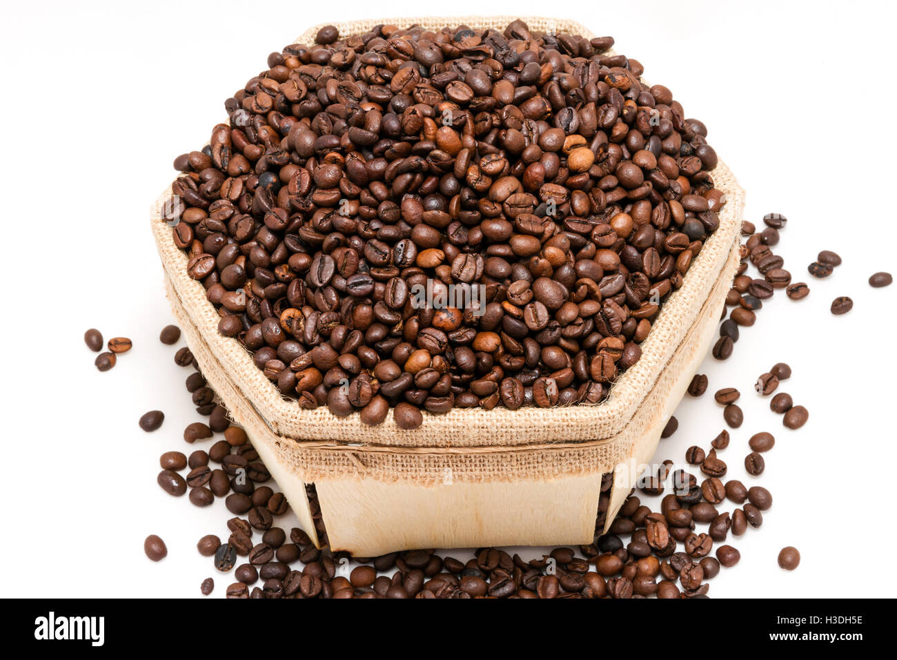 a lot of roasted coffee beans in a box made of natural materials on a ...