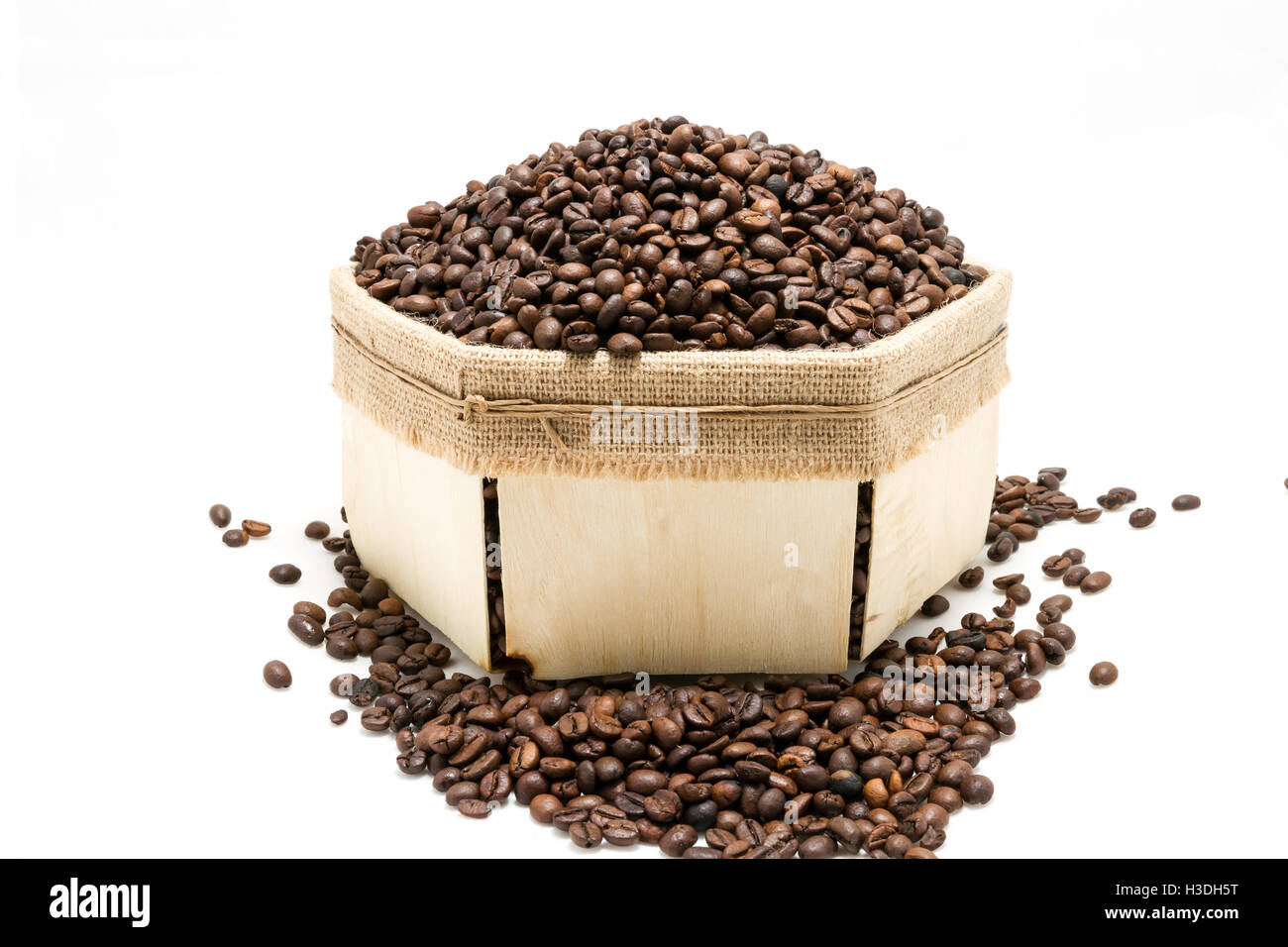 a lot of roasted coffee beans in a box made of natural materials on a ...