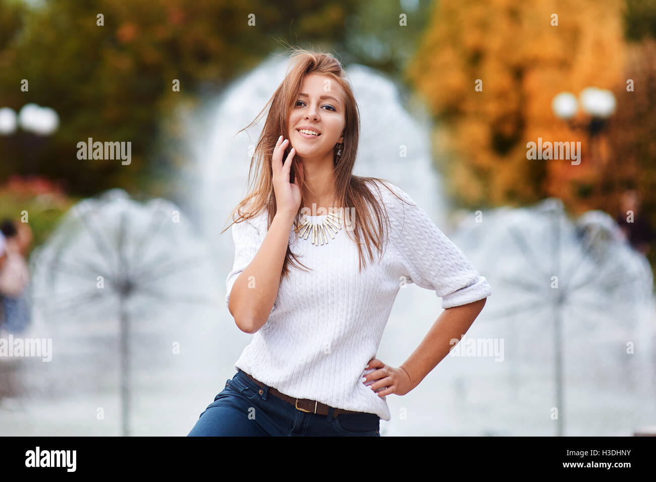 Young beautiful woman walking and posing in city near fountains Stock ...