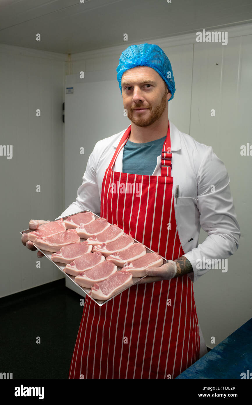 Portrait of butcher holding a tray of steaks Stock Photo - Alamy