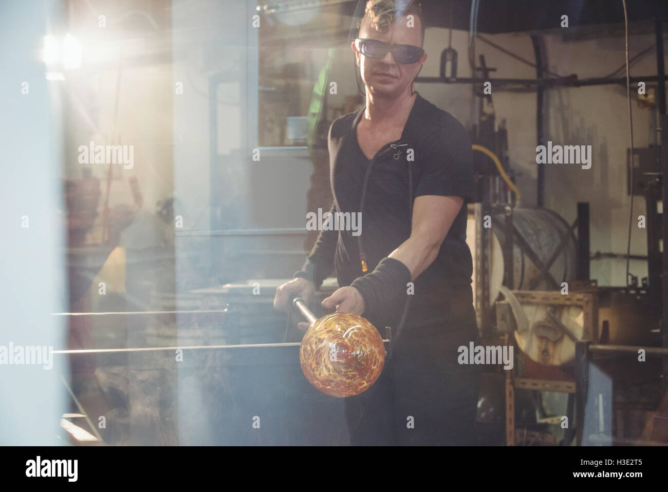 Glassblower shaping a molten glass Stock Photo - Alamy