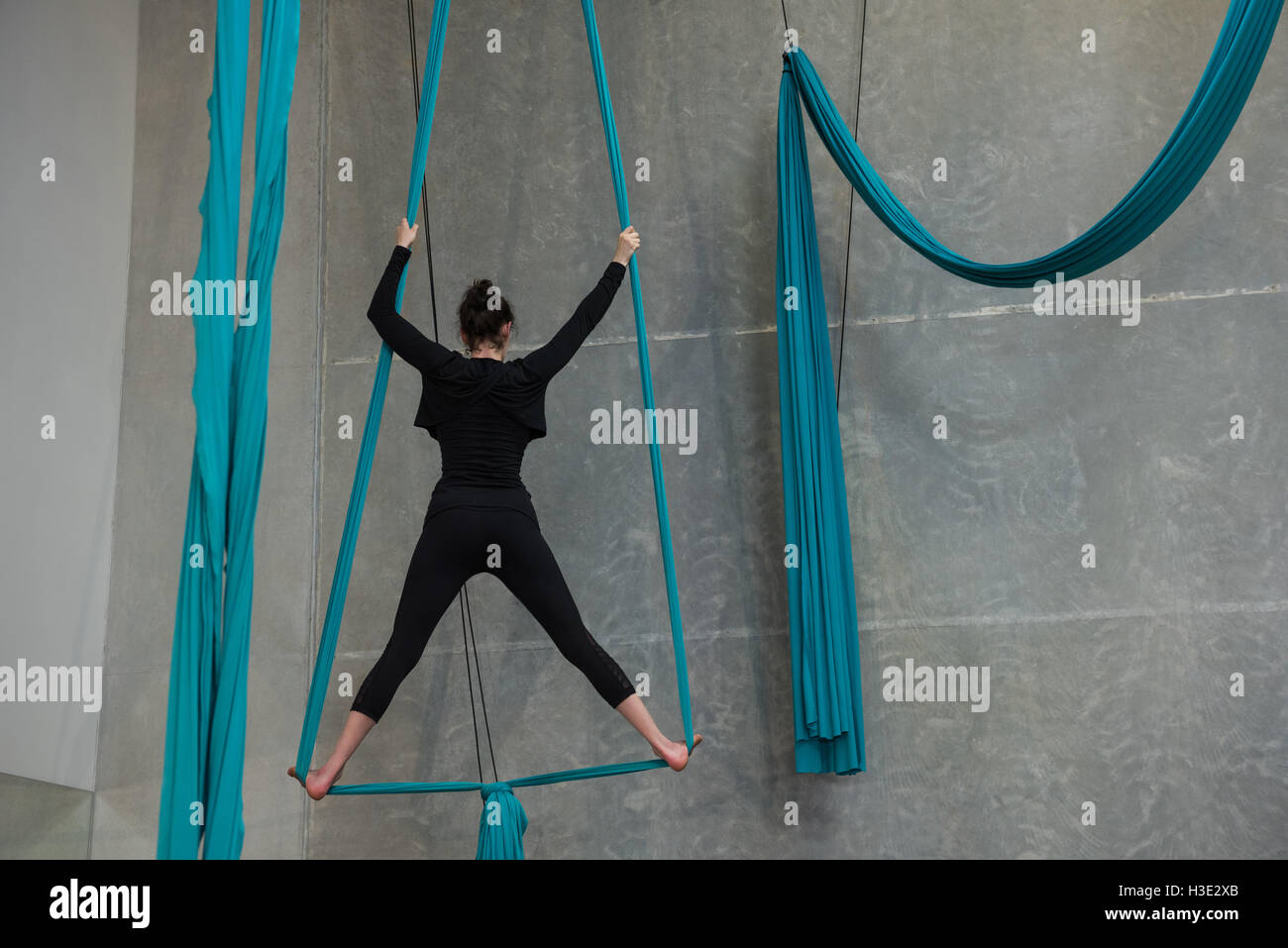 Gymnast exercising on blue fabric rope Stock Photo - Alamy