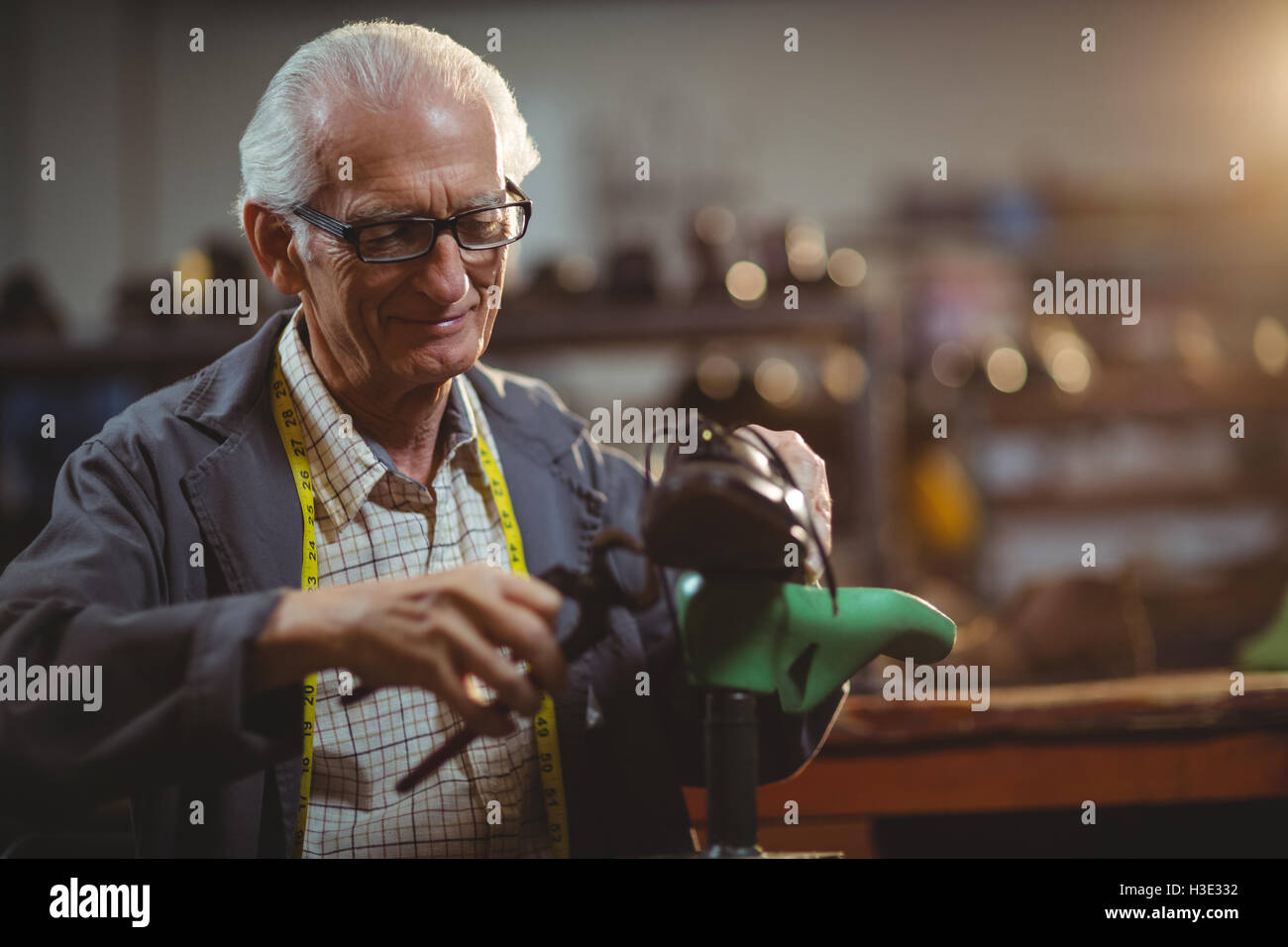 Shoemaker repairing a shoe Stock Photo - Alamy