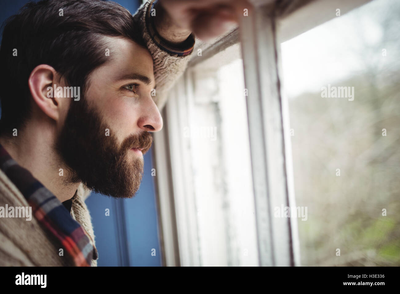 Man looking through window Stock Photo - Alamy