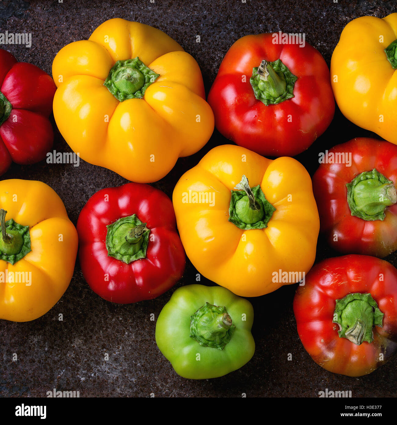 Variety of colorful red, green, yellow paprika bell peppers over old ...