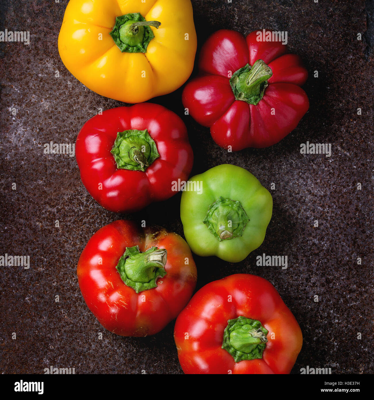 Variety of colorful red, green, yellow paprika bell peppers over old ...