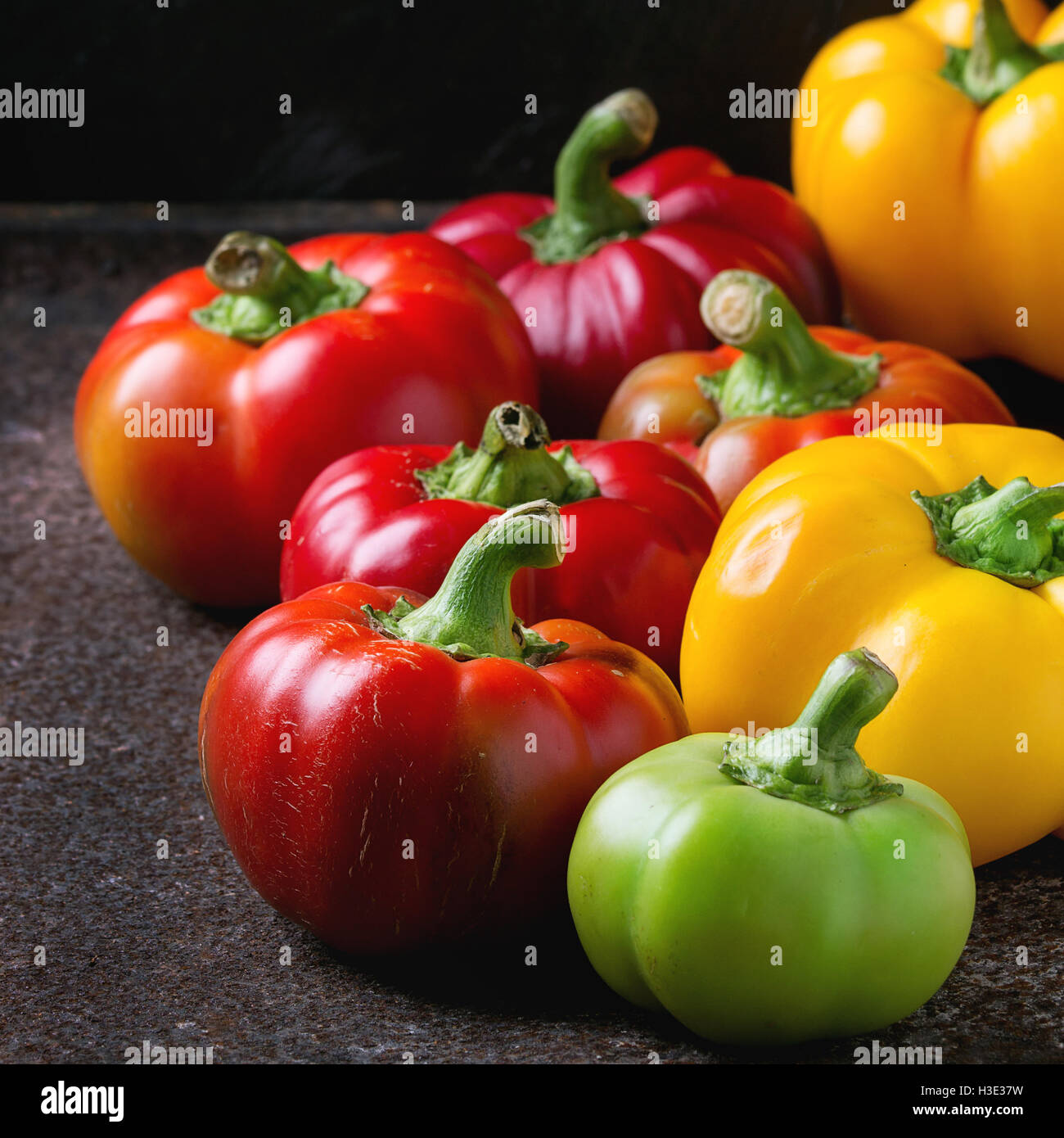 Variety of colorful red, green, yellow paprika bell peppers over old ...