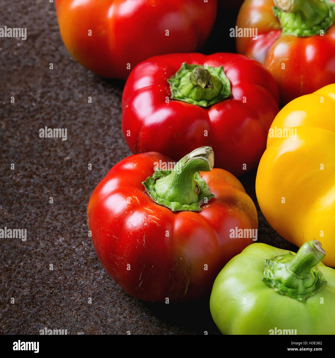 Variety of colorful red, green, yellow paprika bell peppers over old ...