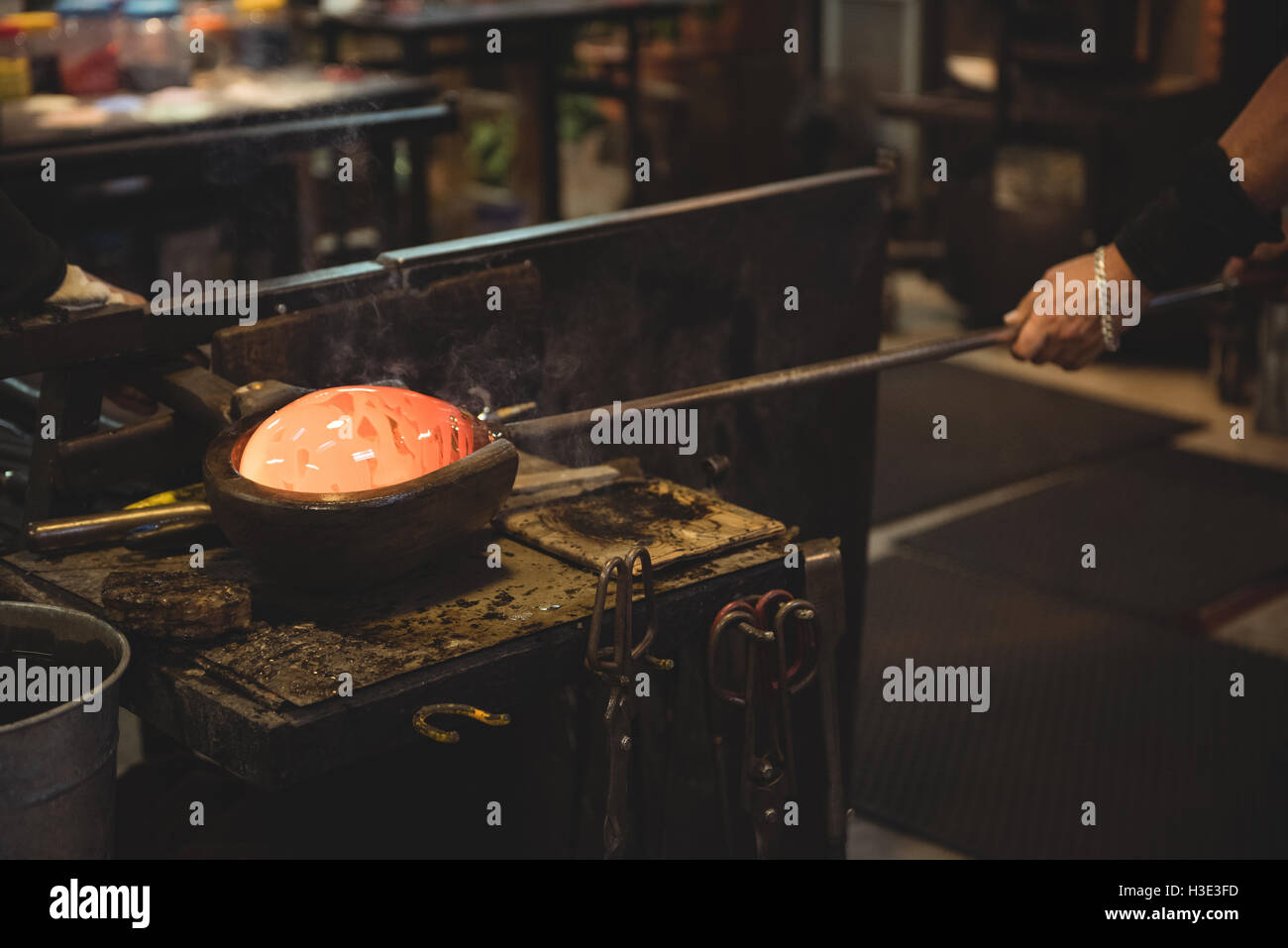 Glassblower forming and shaping a molten glass Stock Photo - Alamy