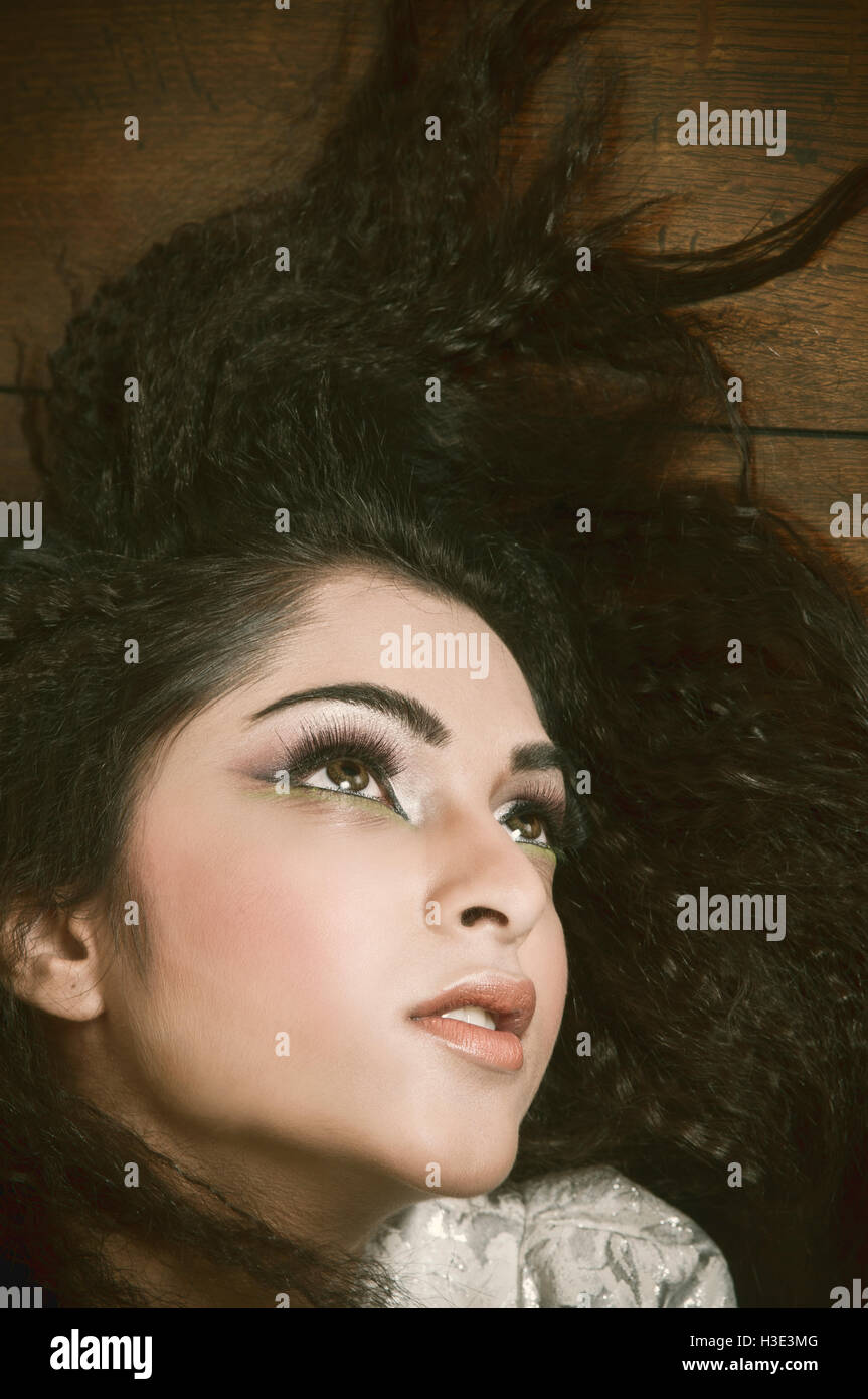 Young woman laying down on the floor looking up Stock Photo - Alamy