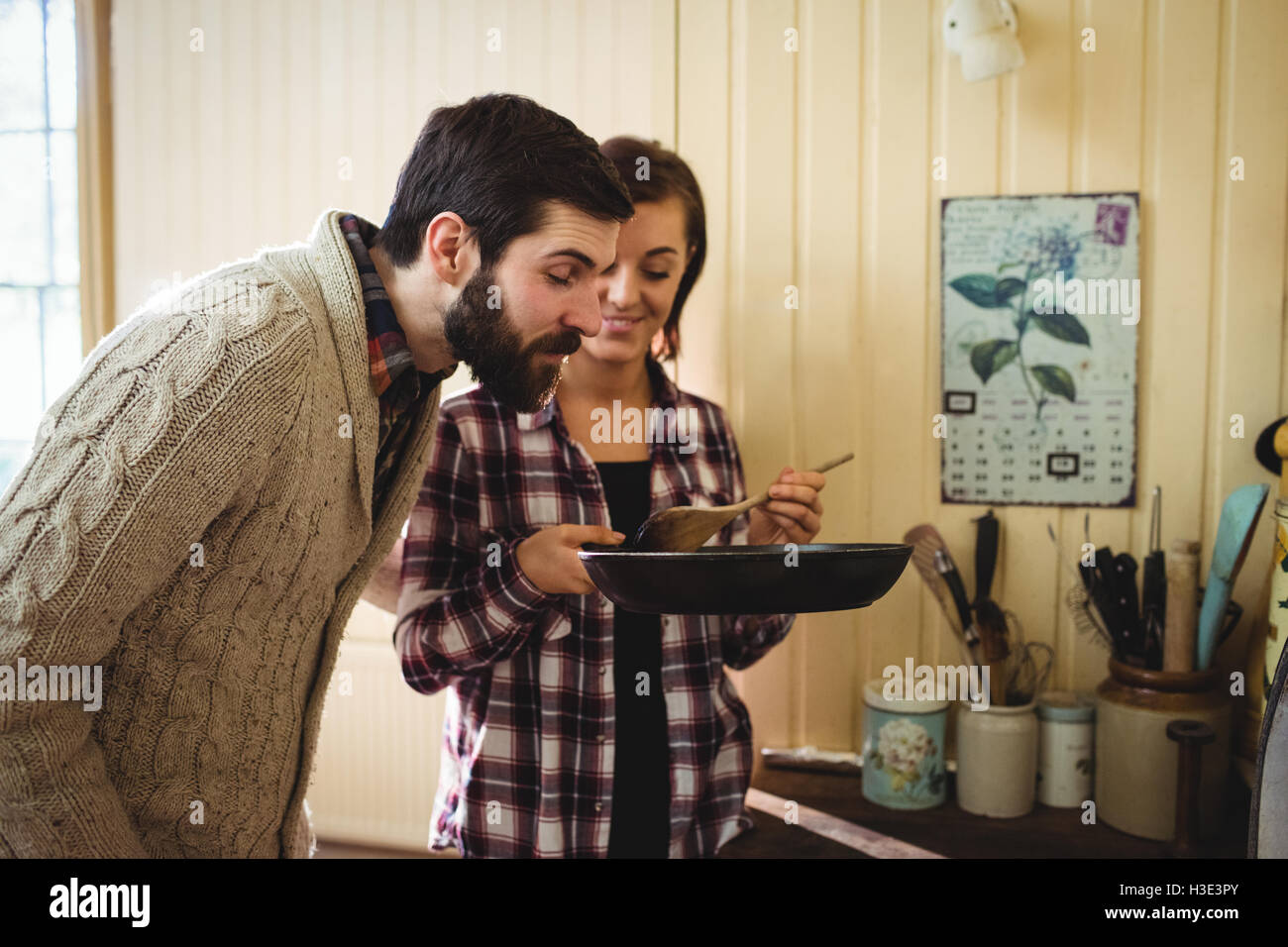 Man smelling food prepared by woman Stock Photo - Alamy