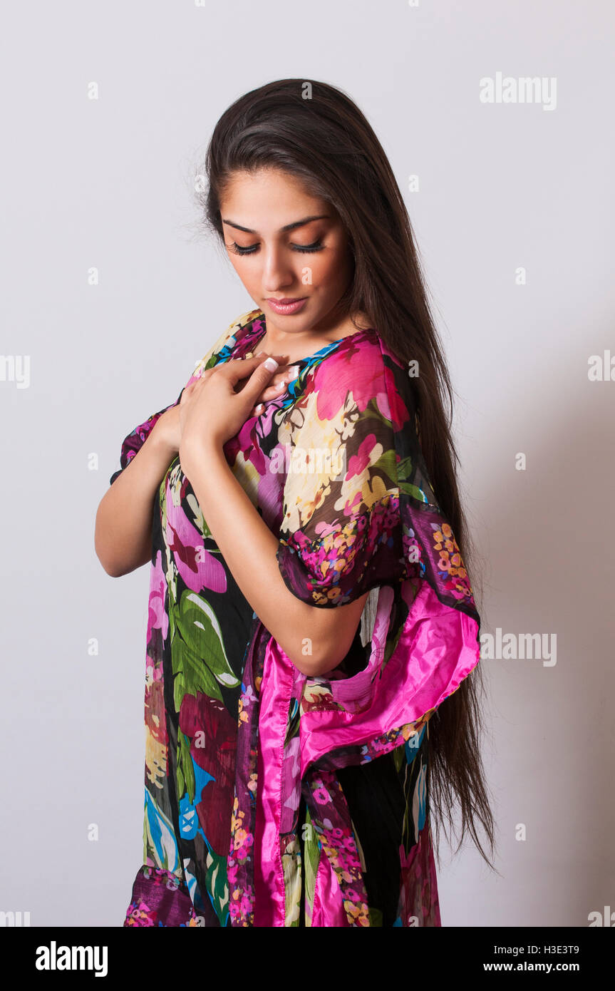 Beautiful Indian woman with long hair hands over heart Stock Photo - Alamy