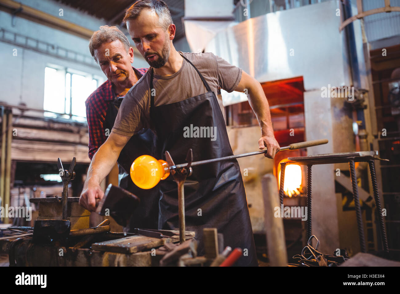 Glassblower forming and shaping a molten glass Stock Photo - Alamy