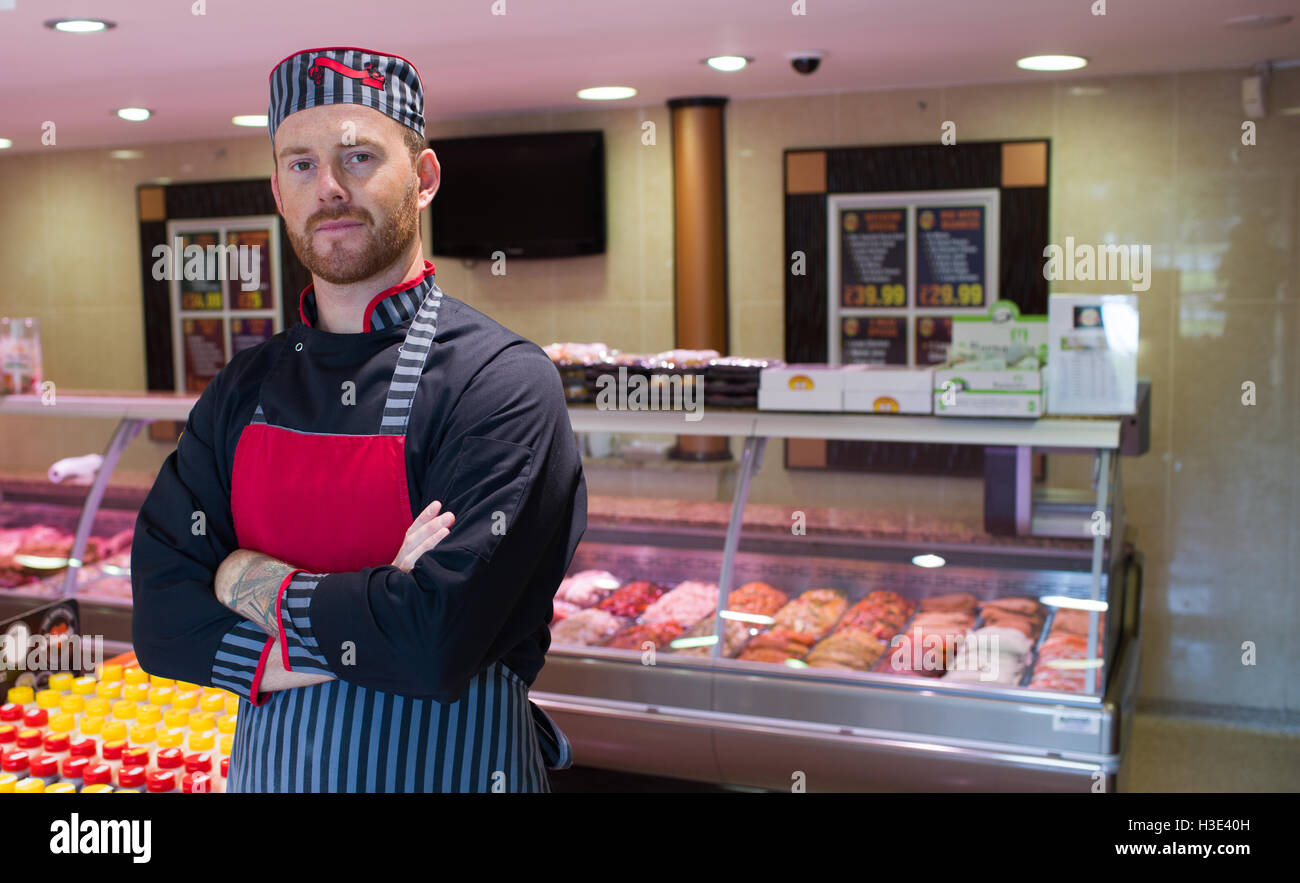 Butcher standing in meat shop with his hands crossed Stock Photo - Alamy