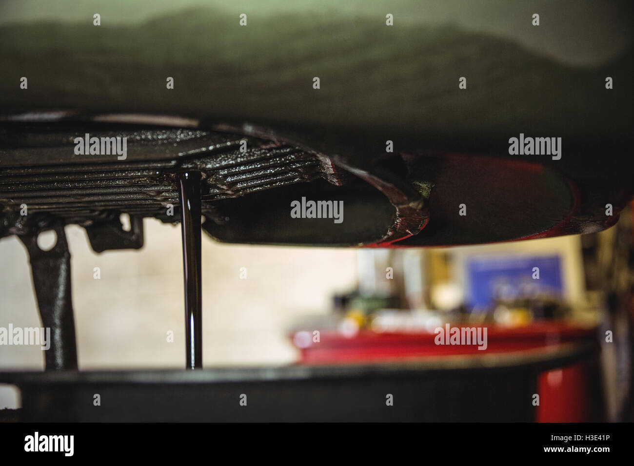 Oil falling from motorbike engine Stock Photo - Alamy