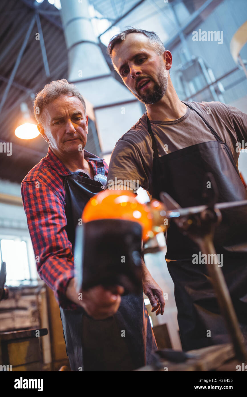 Glassblower forming and shaping a molten glass Stock Photo - Alamy