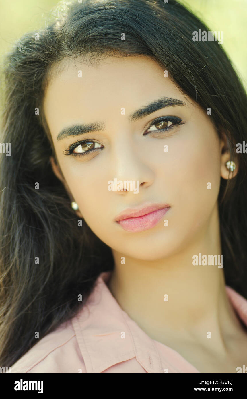 Beautiful young woman staring outdoors Stock Photo - Alamy