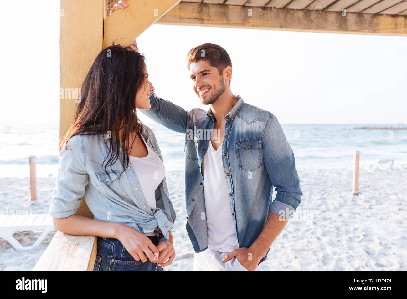 Young cheerful beautiful couple flirting at the beach Stock Photo - Alamy