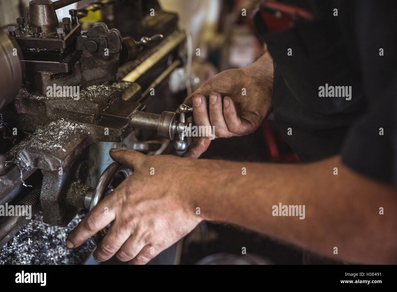 Mechanic working on a lathe machine Stock Photo - Alamy