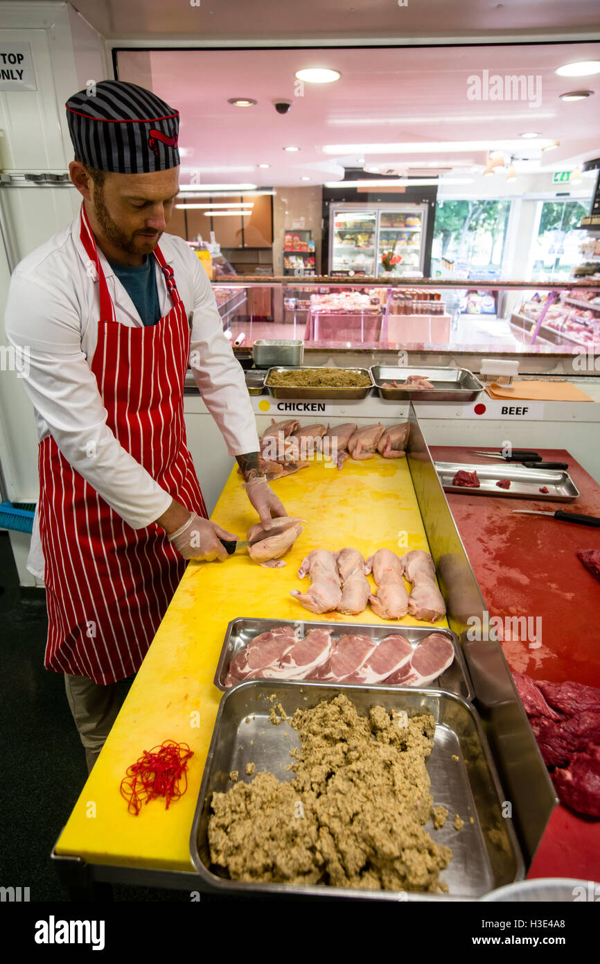 Butcher chopping chicken on work counter Stock Photo - Alamy