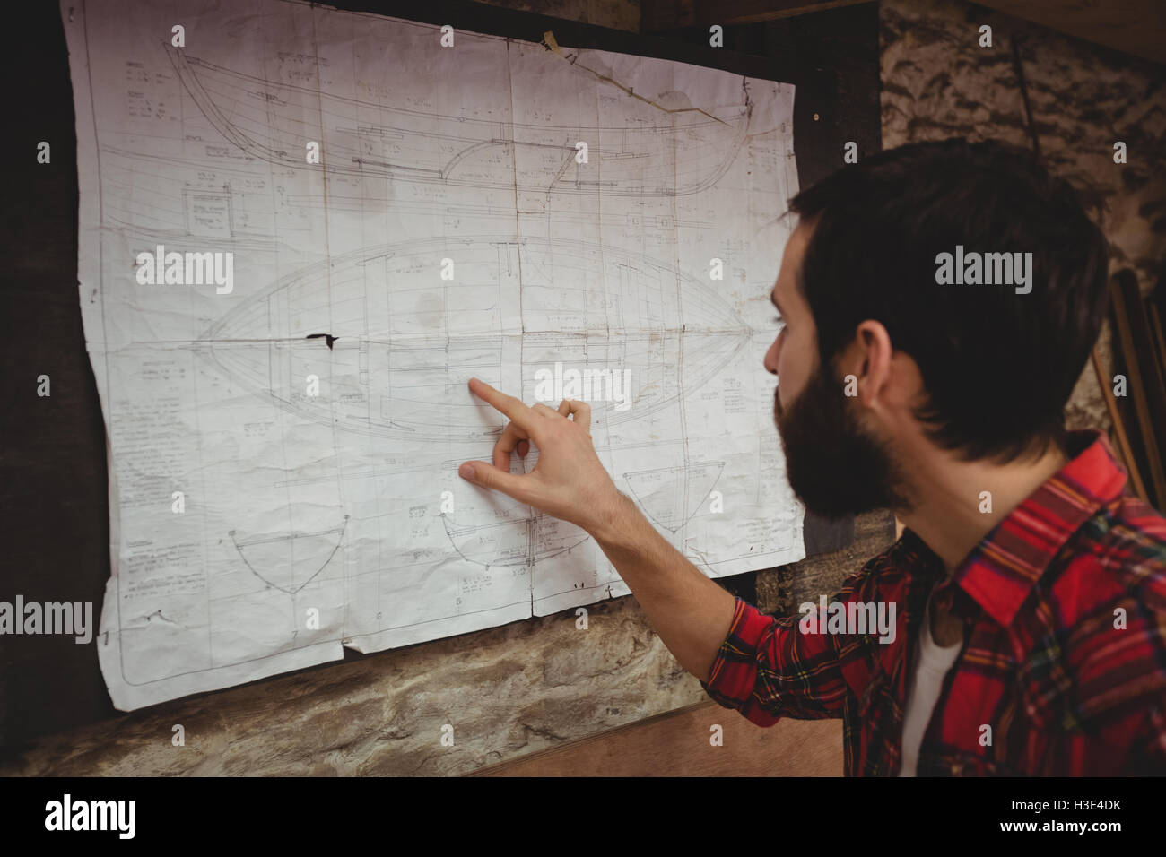 Man looking at blueprint Stock Photo - Alamy