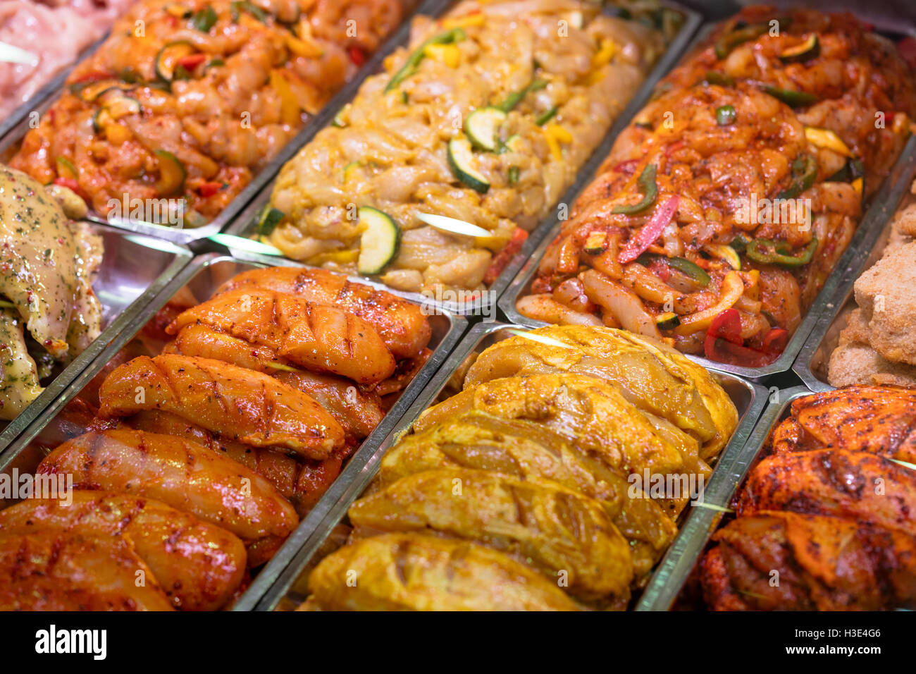 Variety of marinated meat at display counter Stock Photo - Alamy