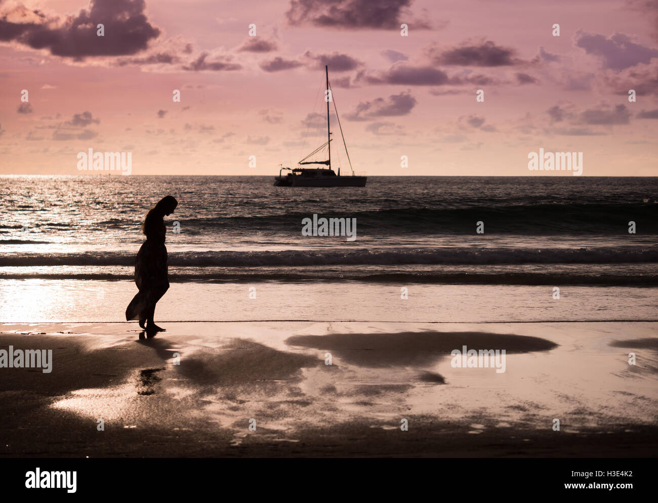 Young woman looking sunset on the beach Stock Photo - Alamy
