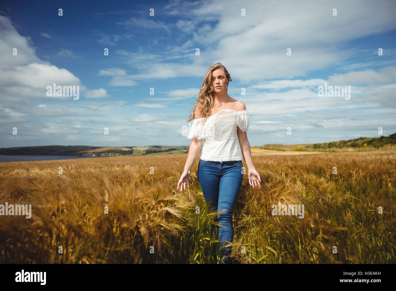 Woman walking through wheat field hi-res stock photography and images ...