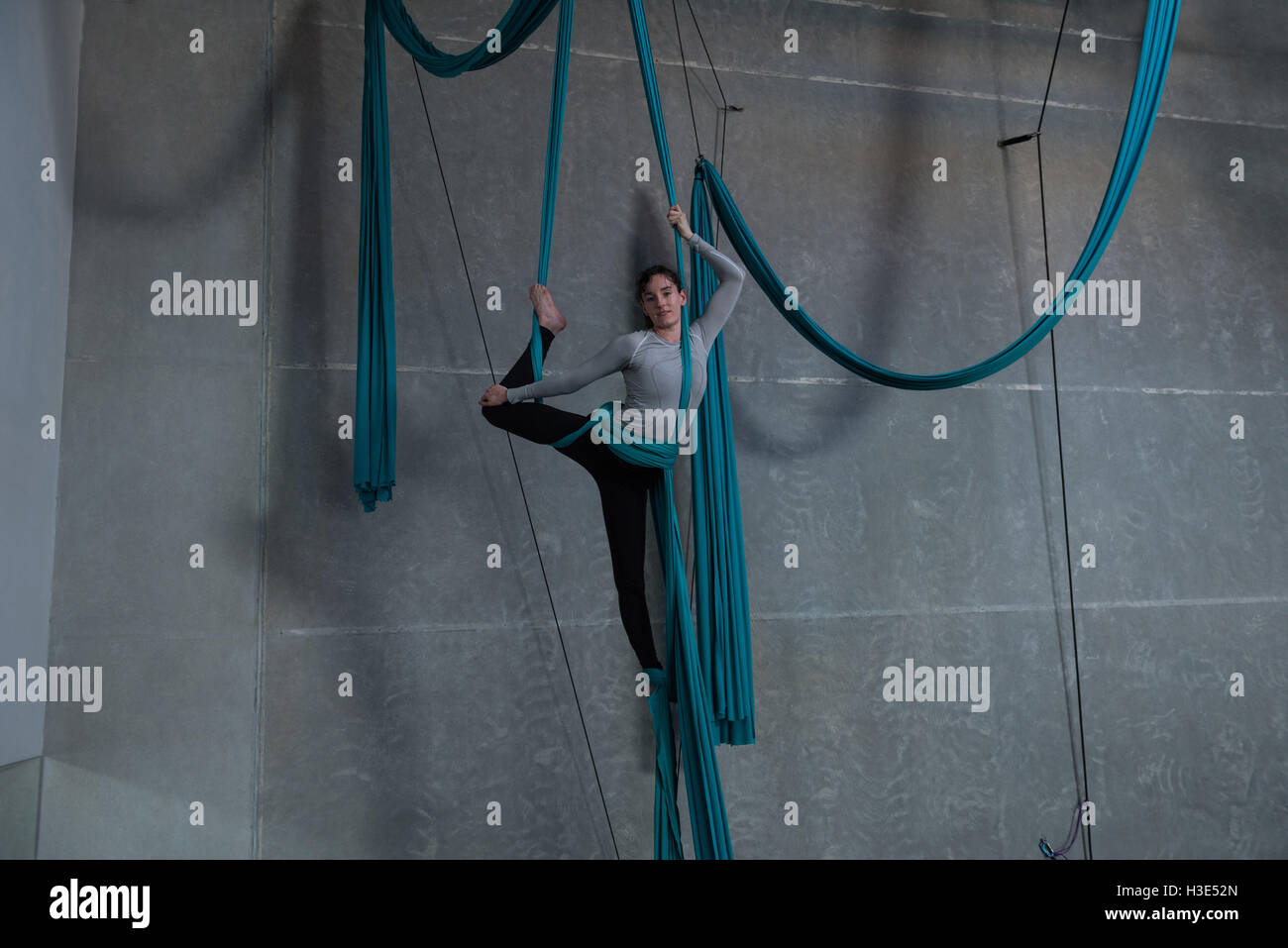 Gymnast exercising on blue fabric rope Stock Photo - Alamy
