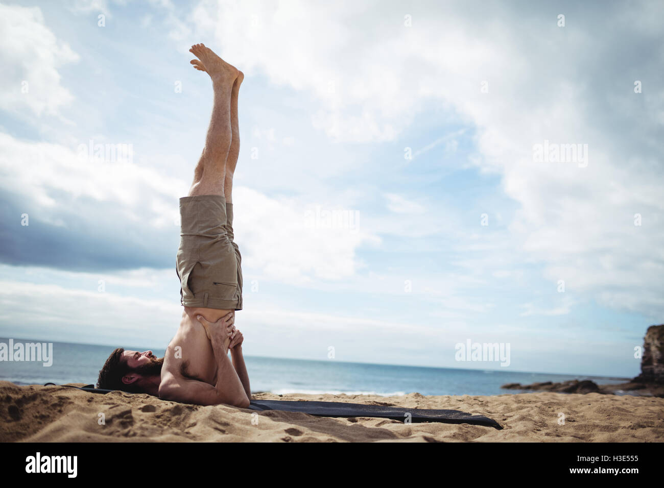 Man performing yoga Stock Photo - Alamy