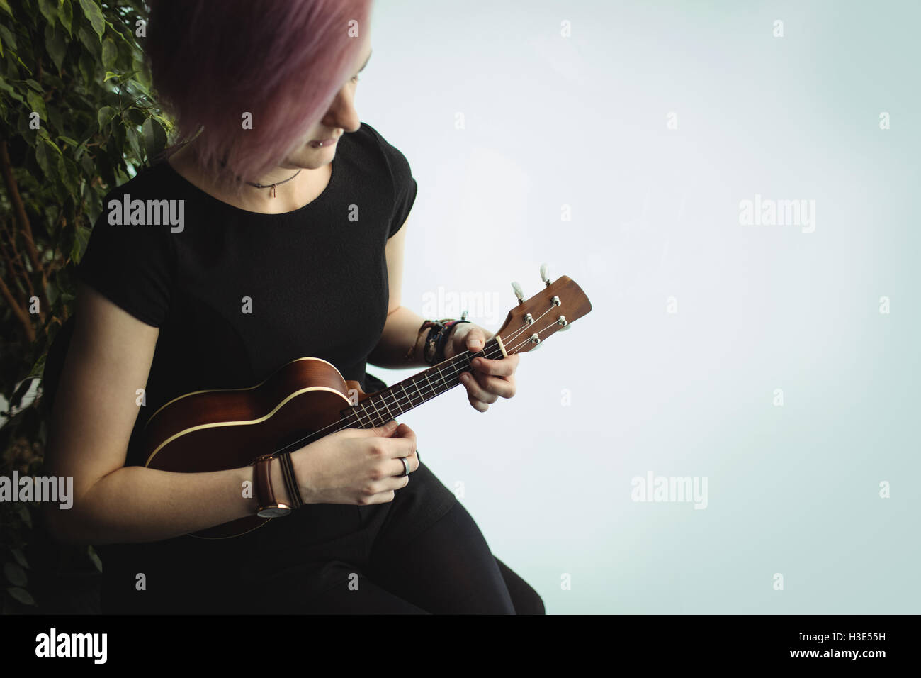 Woman playing a guitar Stock Photo - Alamy