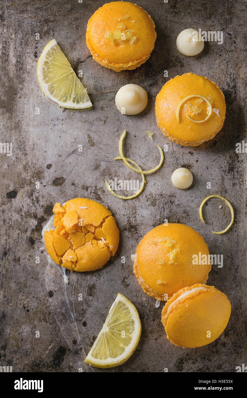 Whole and broken orange lemon homemade macaroons with chopped white ...