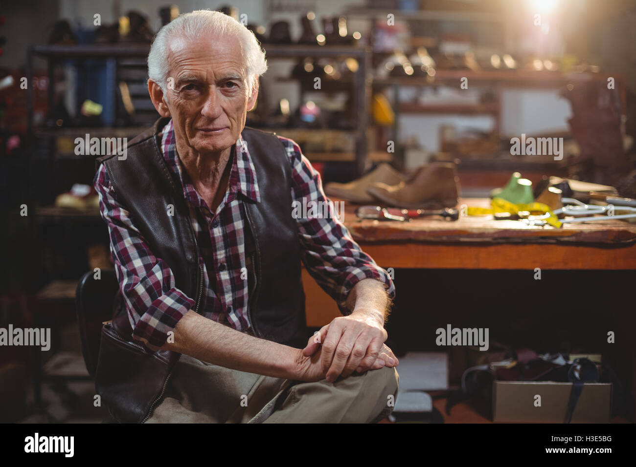 Portrait of shoemaker sitting in workshop Stock Photo - Alamy
