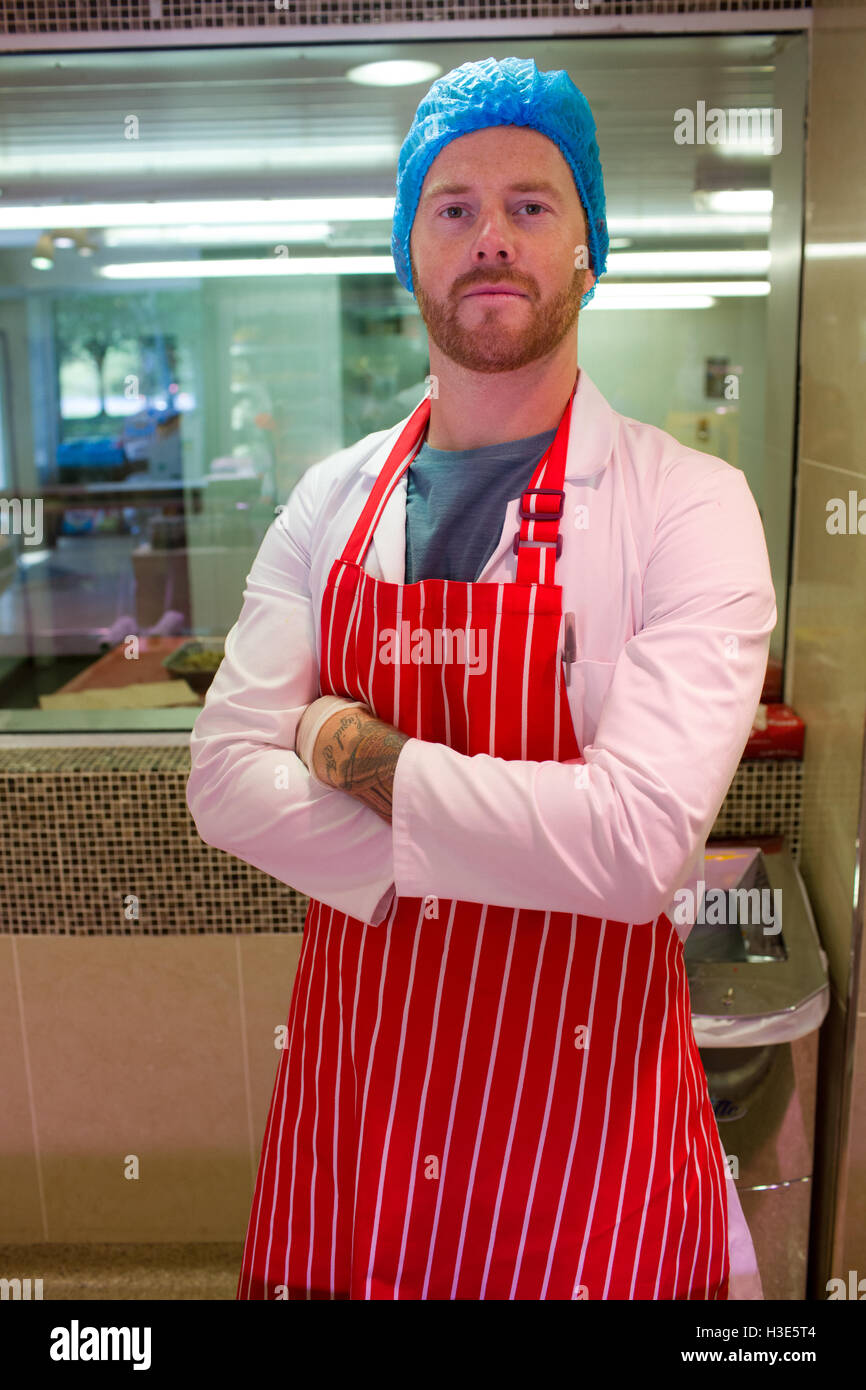Butcher standing in meat shop with his hands crossed Stock Photo - Alamy
