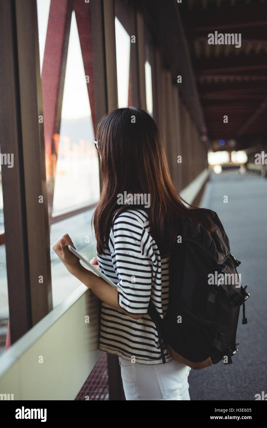 Young woman looking through window Stock Photo - Alamy