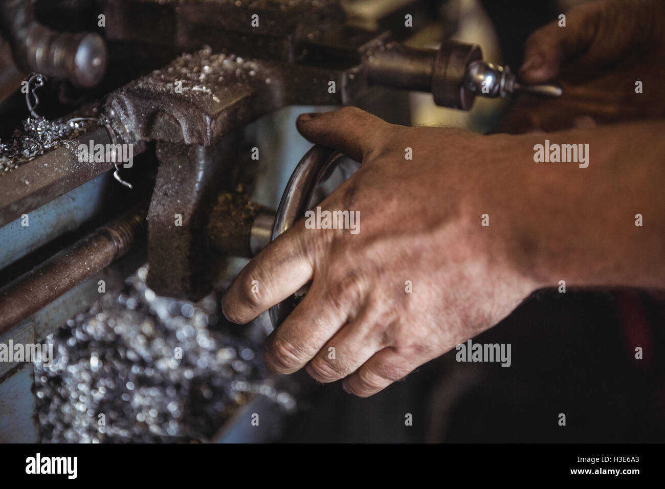Mechanic working on a lathe machine Stock Photo - Alamy
