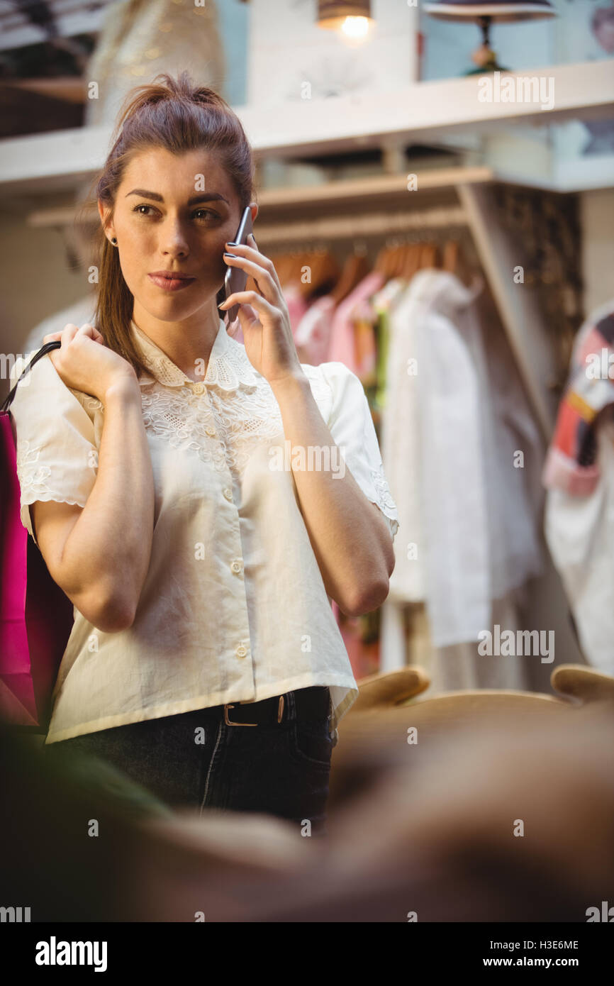Woman talking on mobile phone while shopping Stock Photo - Alamy