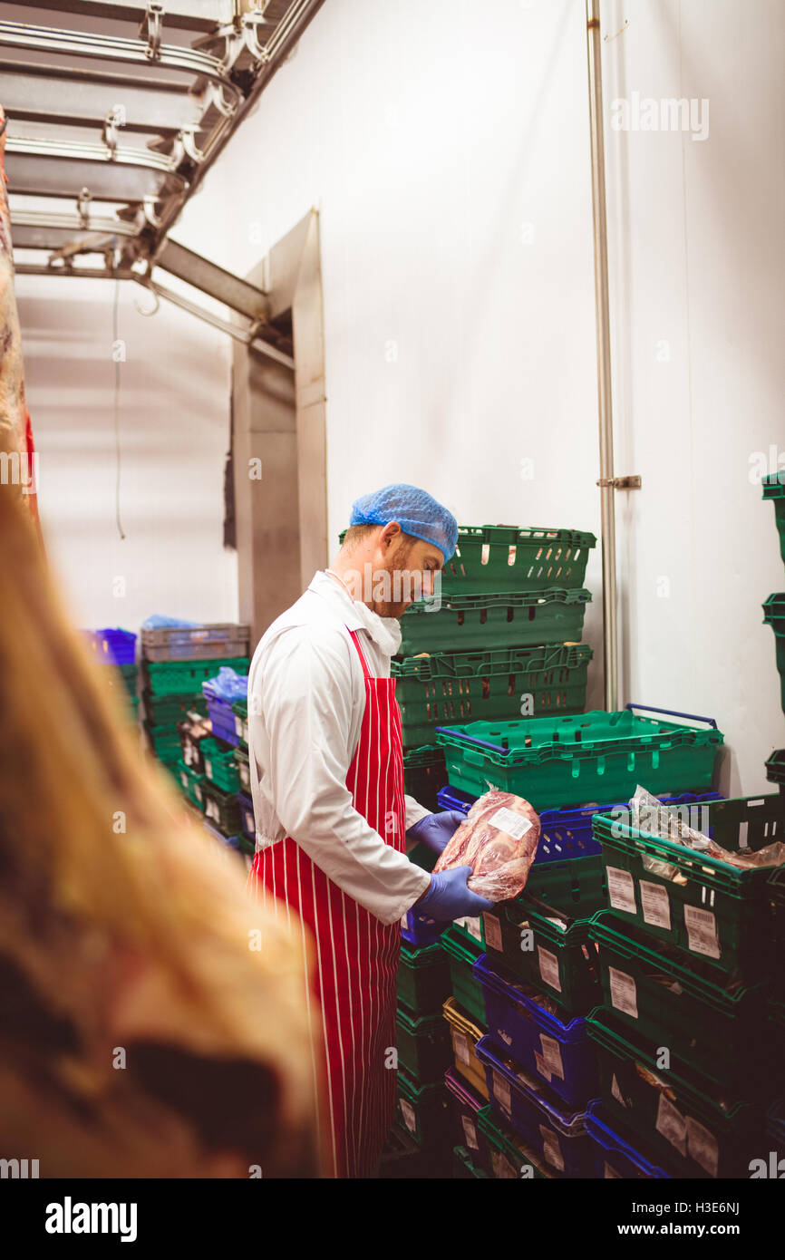 Butcher arranging meat in crates Stock Photo - Alamy
