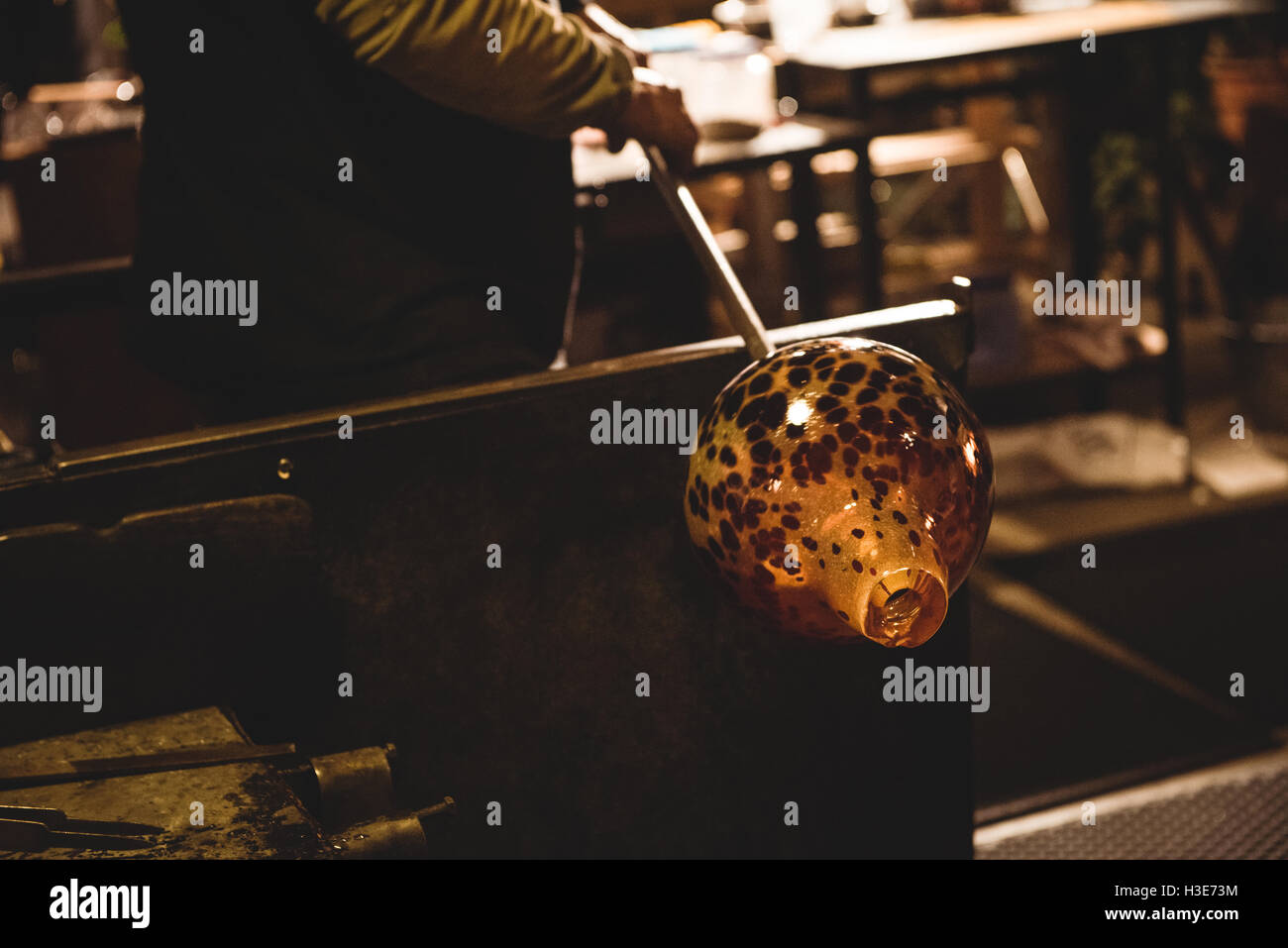 Glassblower shaping a molten glass Stock Photo - Alamy