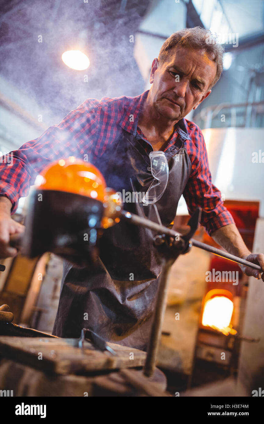 Glassblower forming and shaping a molten glass Stock Photo - Alamy