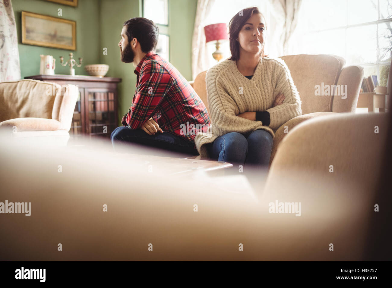 Couple ignoring each other in living room Stock Photo - Alamy